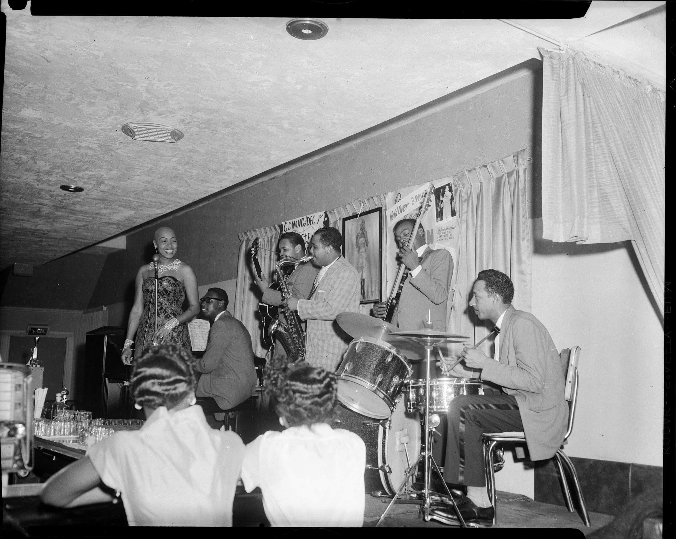 Five piece Band With Female Vocalist On Stage At A Bar CMOA Collection Five piece Band With Female Vocalist On Stage At A Bar CMOA Collection