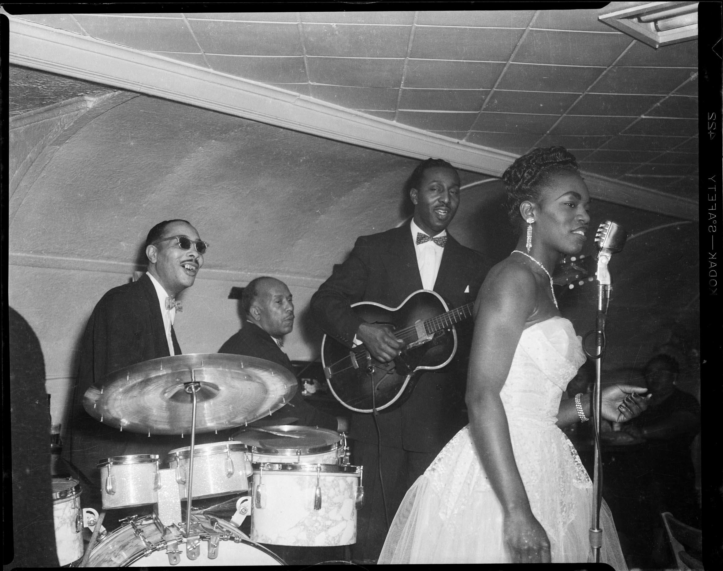 Female Vocalist In Evening Dress Performing With Band Drums Piano female-vocalist-in-evening-dress-performing-with-band-drums-piano