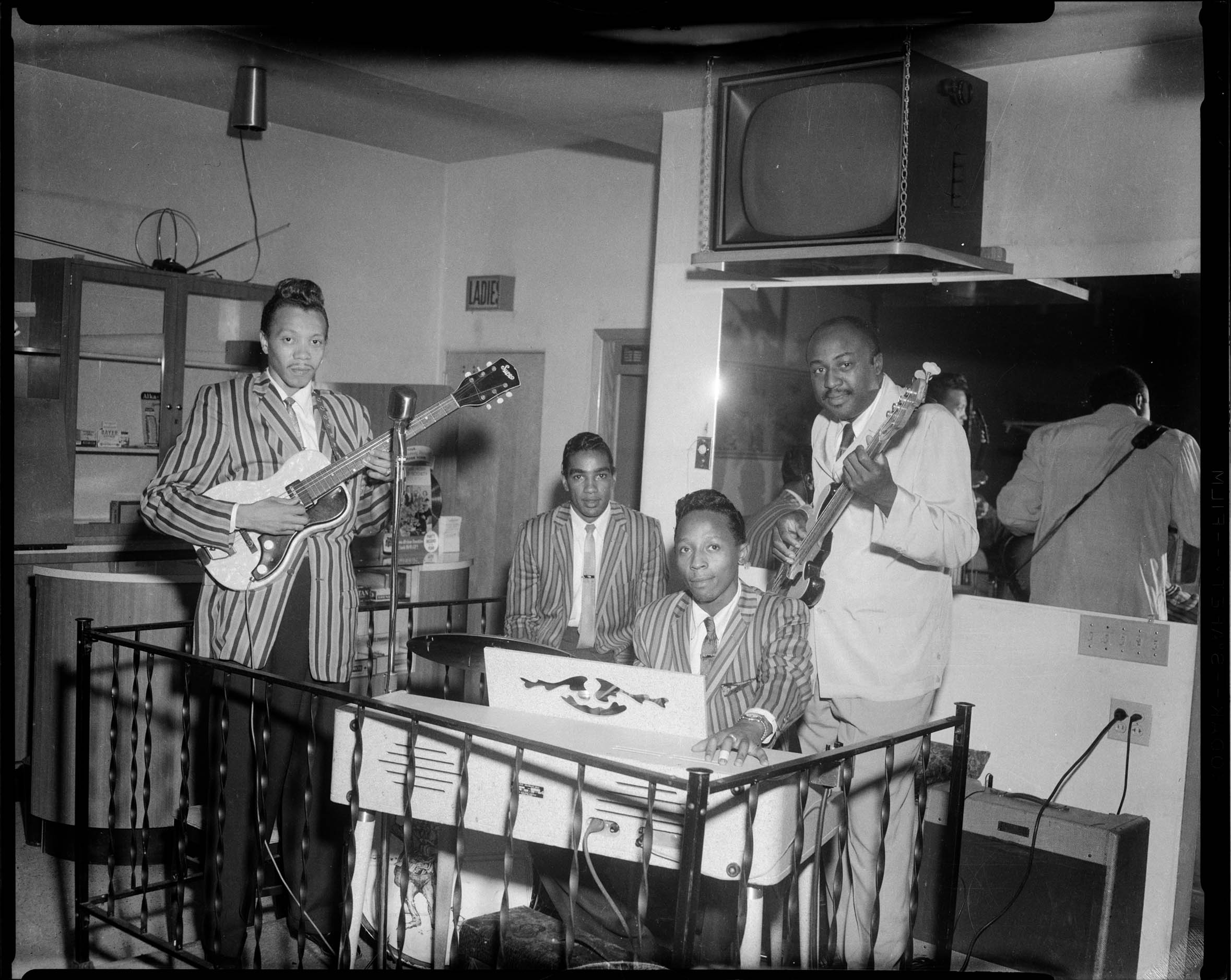 Four Piece Band With Three Musicians Wearing Striped Jackets With four-piece-band-with-three-musicians-wearing-striped-jackets-with