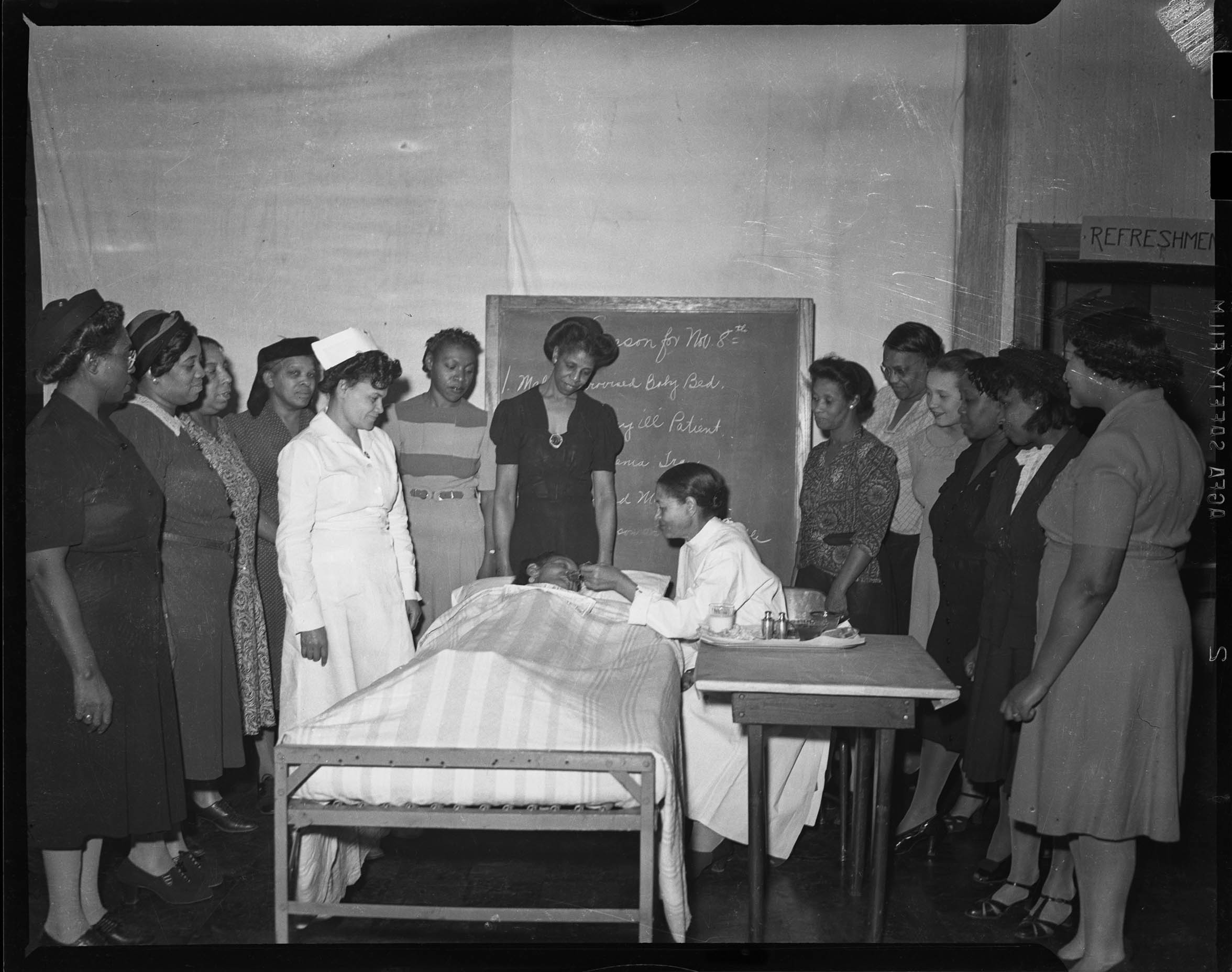 Woman Lying In Bed With Other Women Standing Around Including Eunice